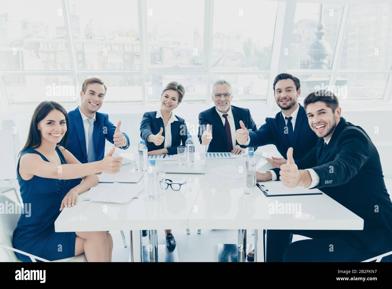 Briefing. Group of famous successful business people showing thumbs up ...