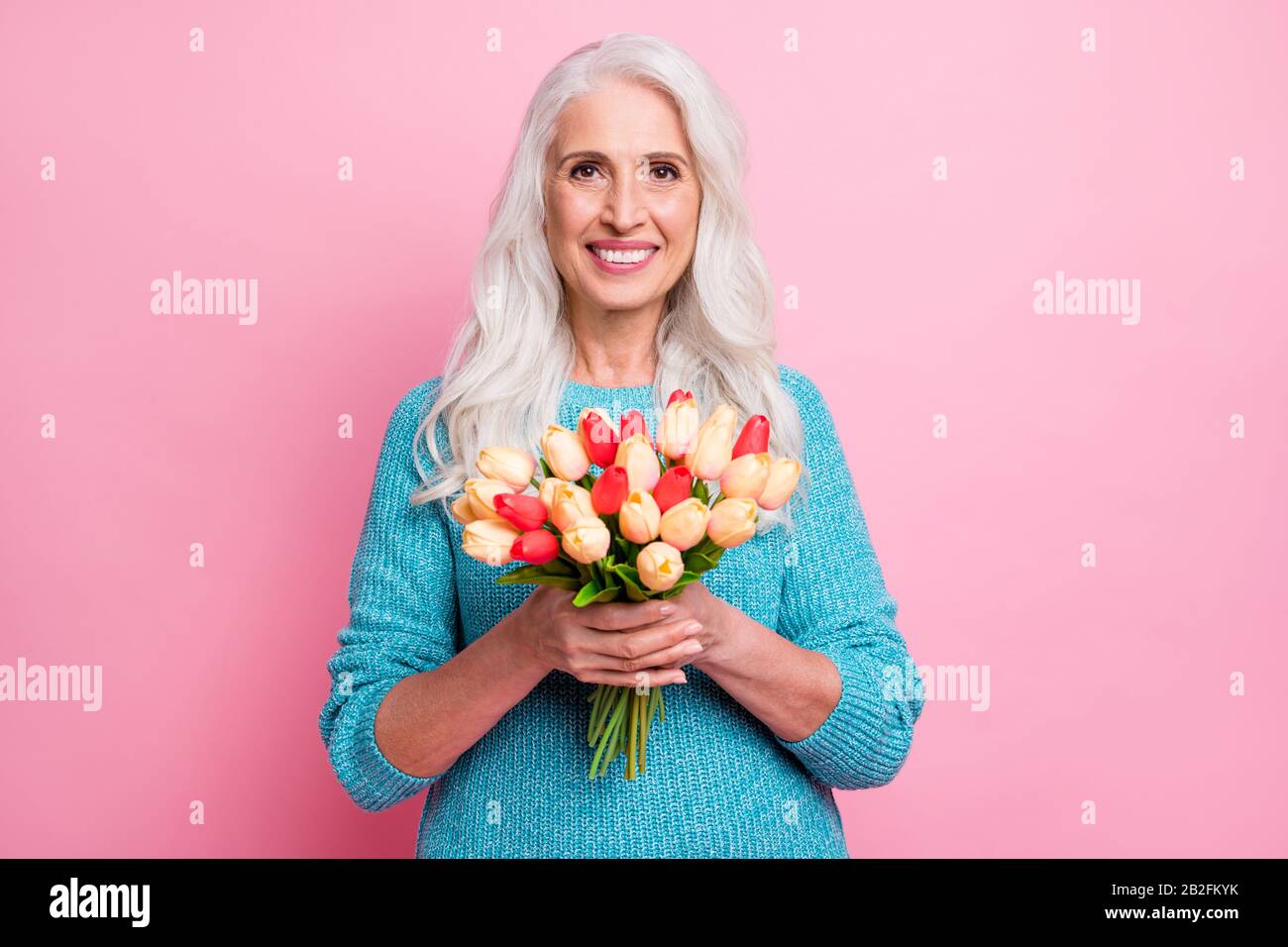 Portrait of charming lovely pretty granny hold bunch with colorful ...