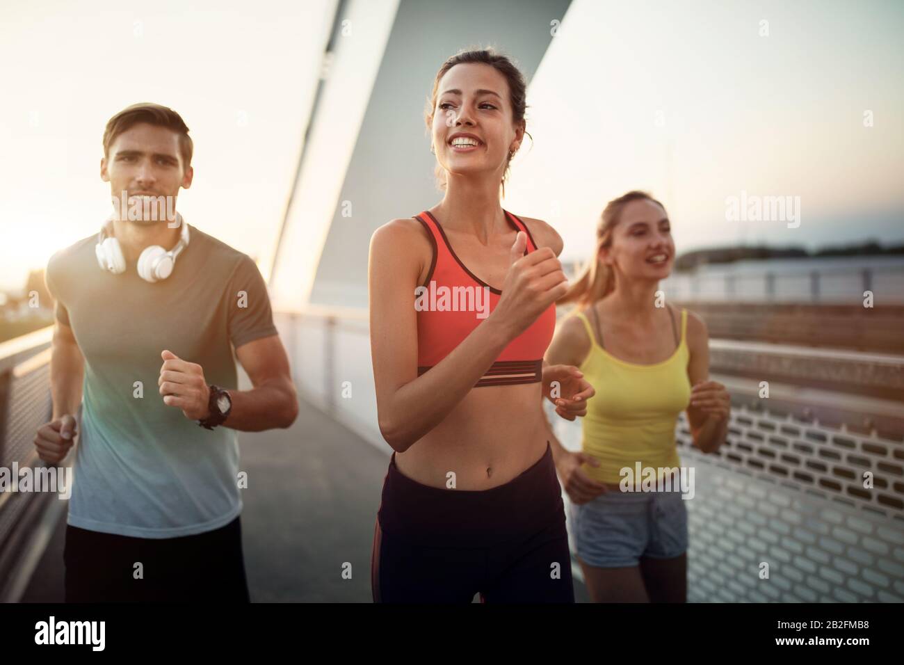 Athletic fit people exercising and running together outdoors Stock ...