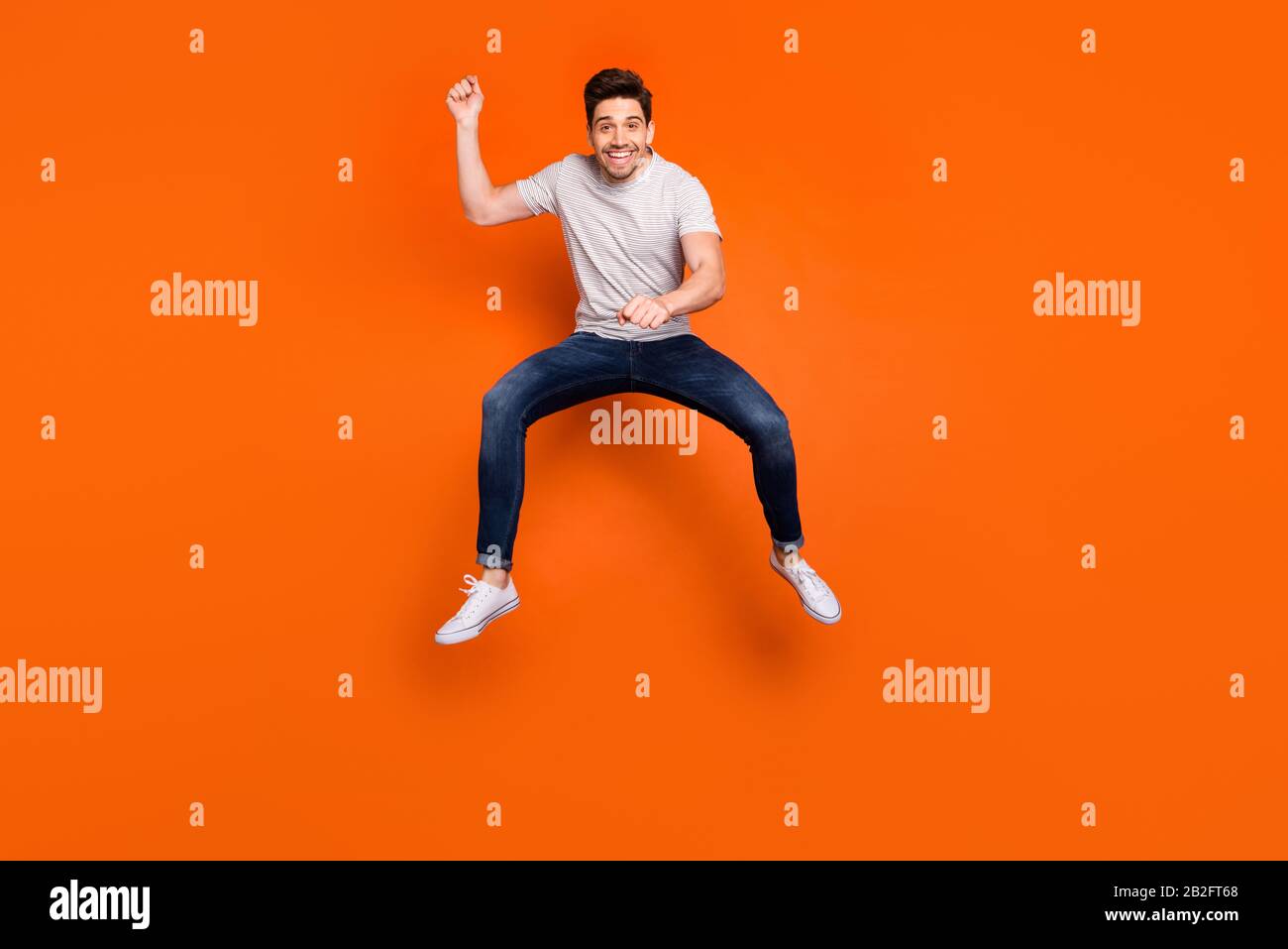 Full length photo of funky guy jump high up pretending horse riding ...