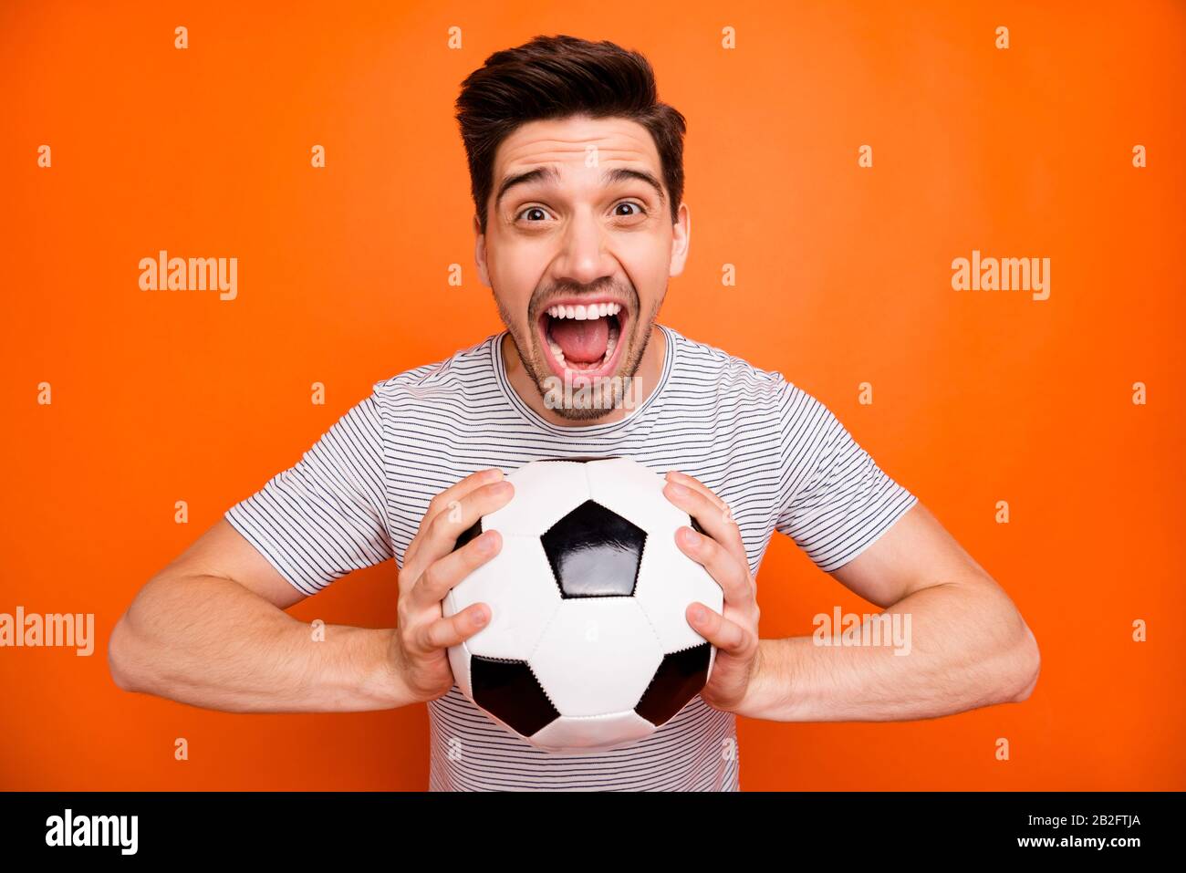 Closeup photo of ecstatic attractive crazy guy hold football leather ...