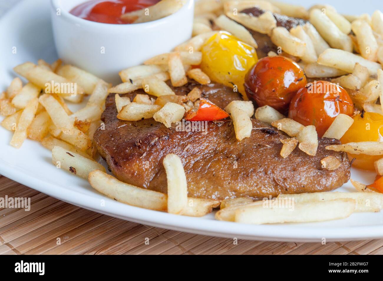 Vegetarian steak made from vegan meat - seitan, with cherry tomatoes ...