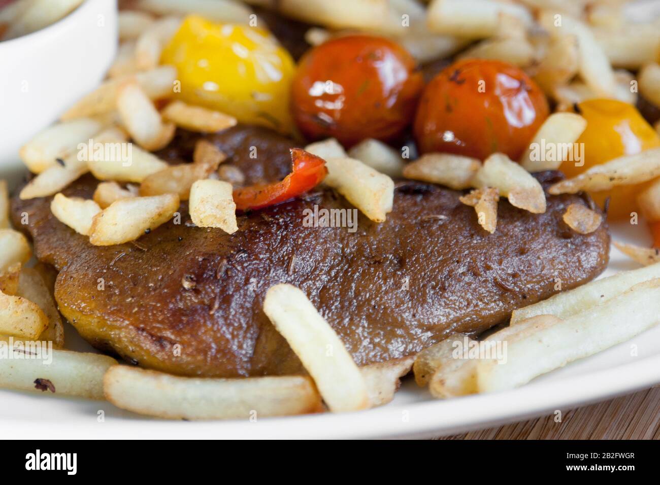 Vegetarian steak made from vegan meat - seitan, with cherry tomatoes ...