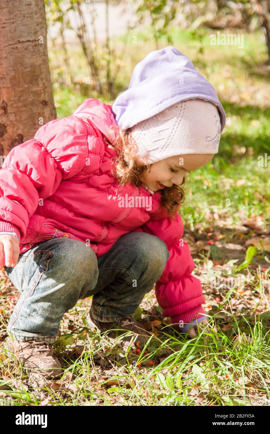 happy little child, baby girl playing in the autumn on the nature walk ...