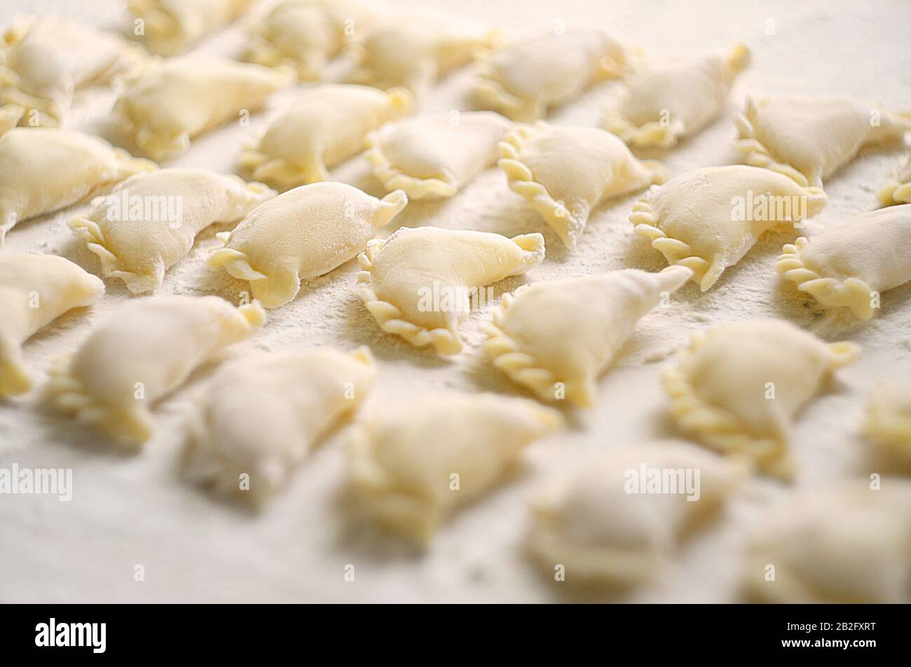 Dumplings (vareniki) with potatoes on white background - traditional ...