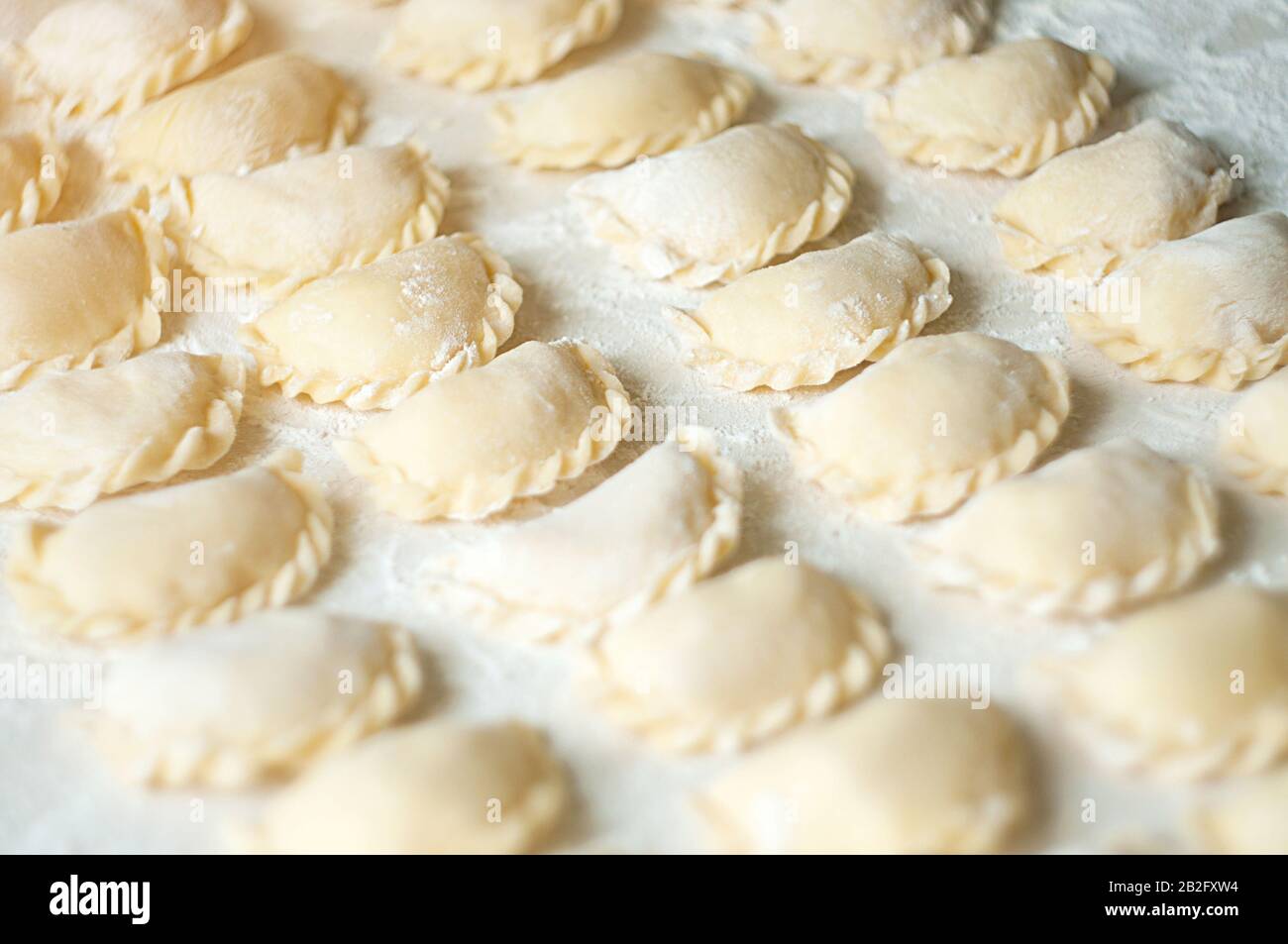Dumplings (vareniki) with potatoes on white background - traditional ...