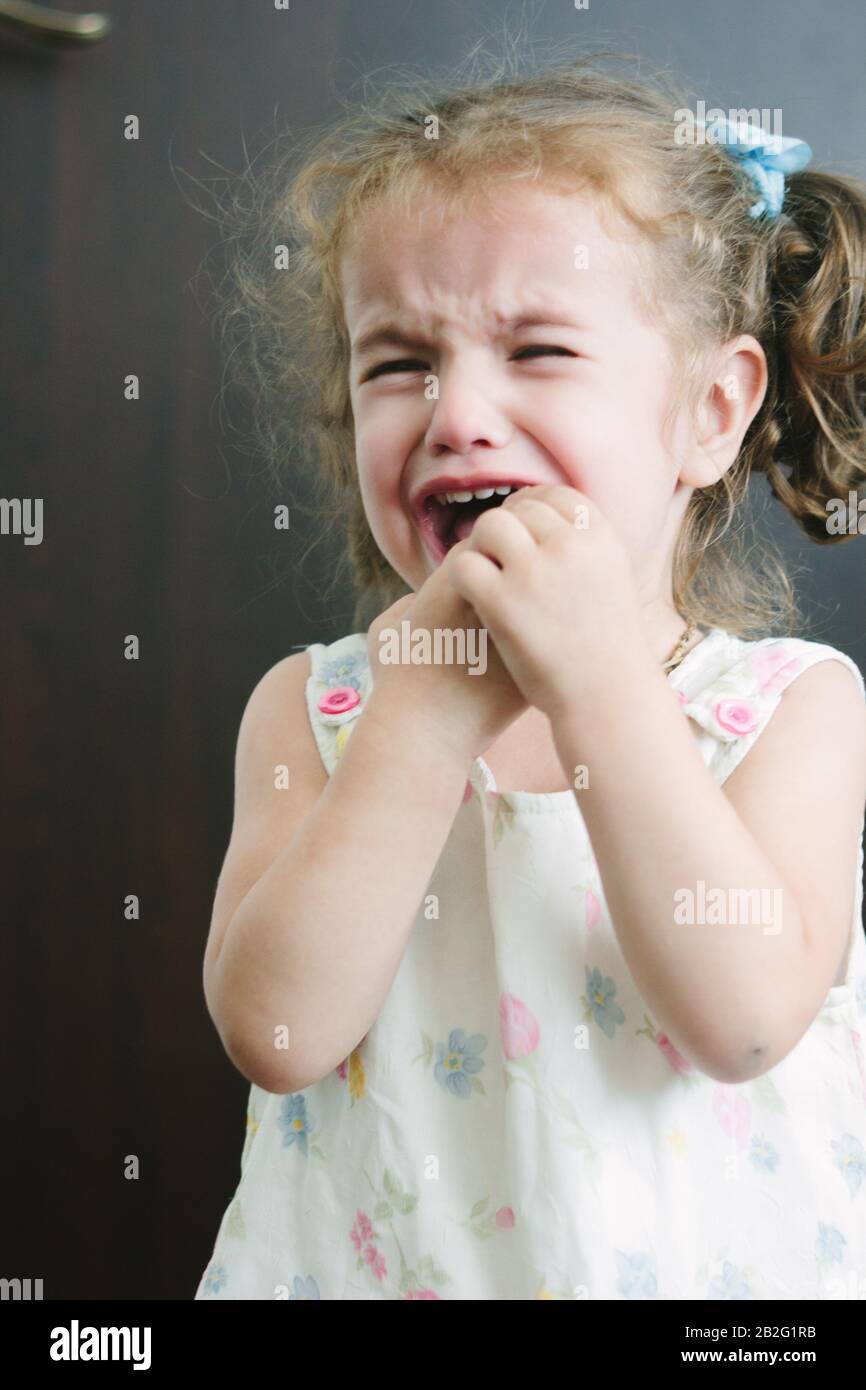 beautiful cute little kid is crying outdoors Stock Photo - Alamy