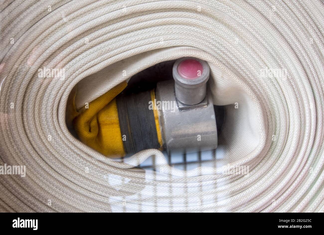Roll of canvas hose in the emergency firefighting box Stock Photo - Alamy