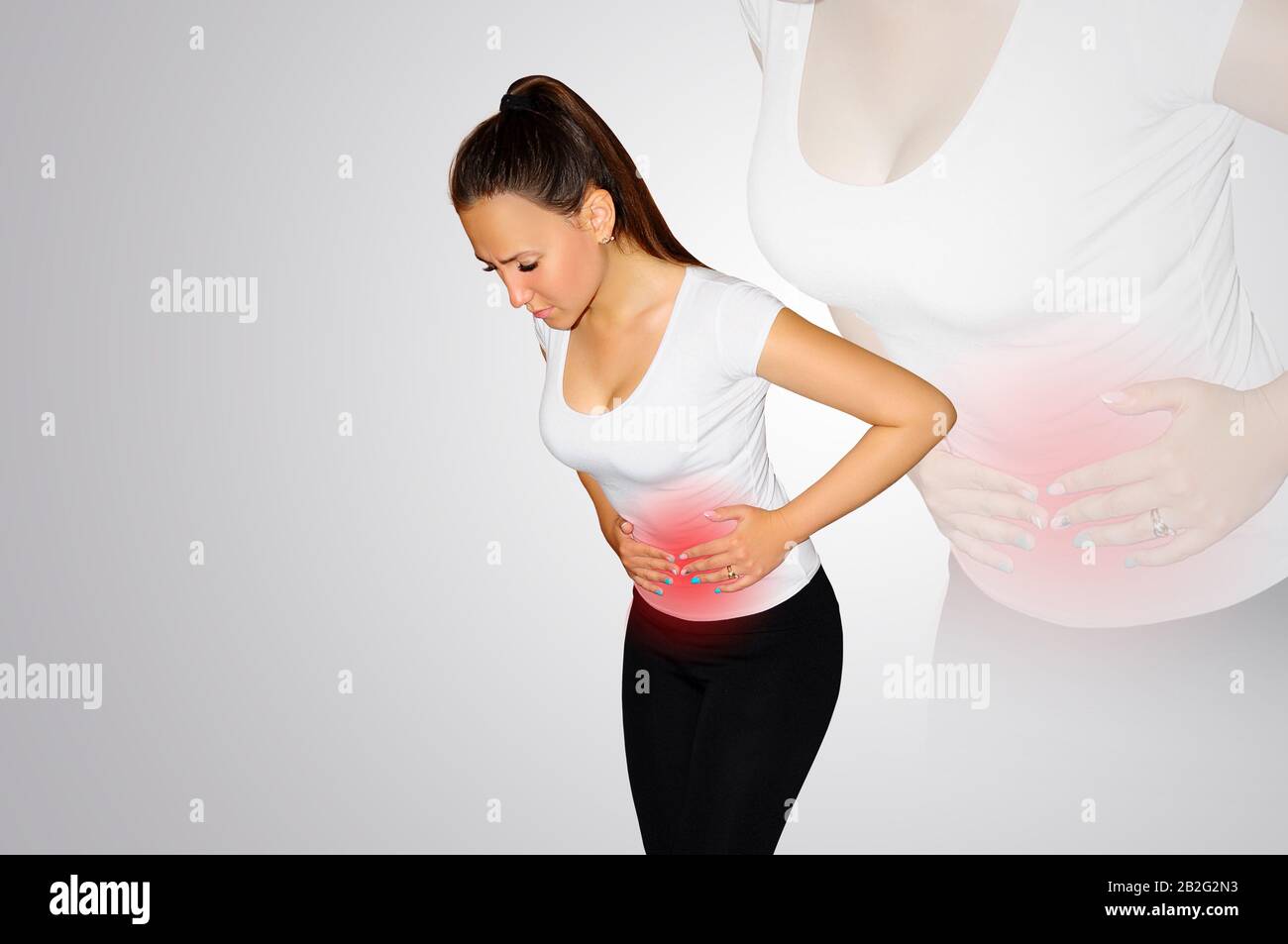 Abdominal pain. A young woman suffers from pain in the abdomen. The ...