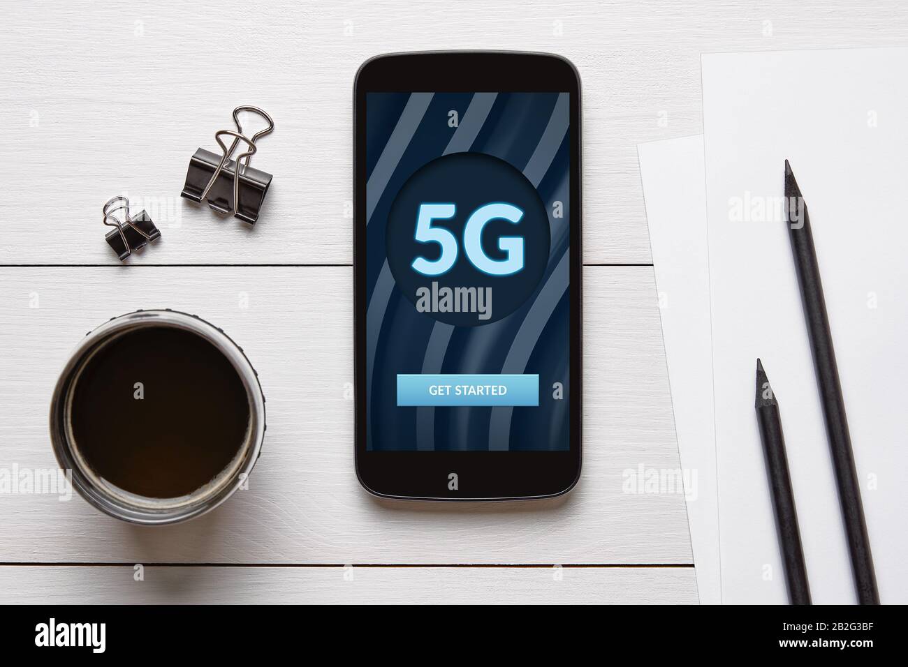 5G network concept on mobile phone screen with office objects on white ...