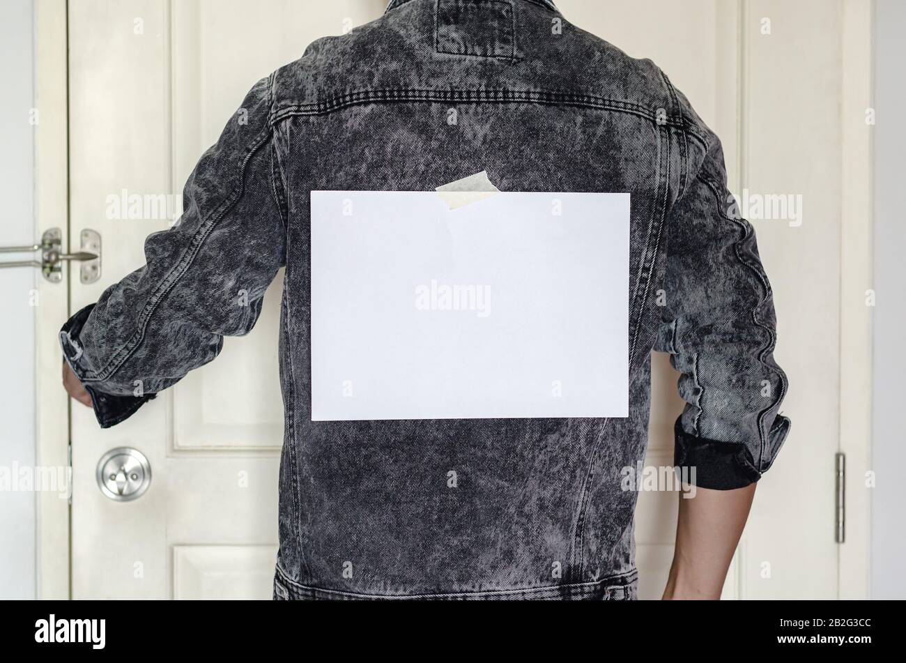 A blank white note on sticky tape of the man back side with empty space ...