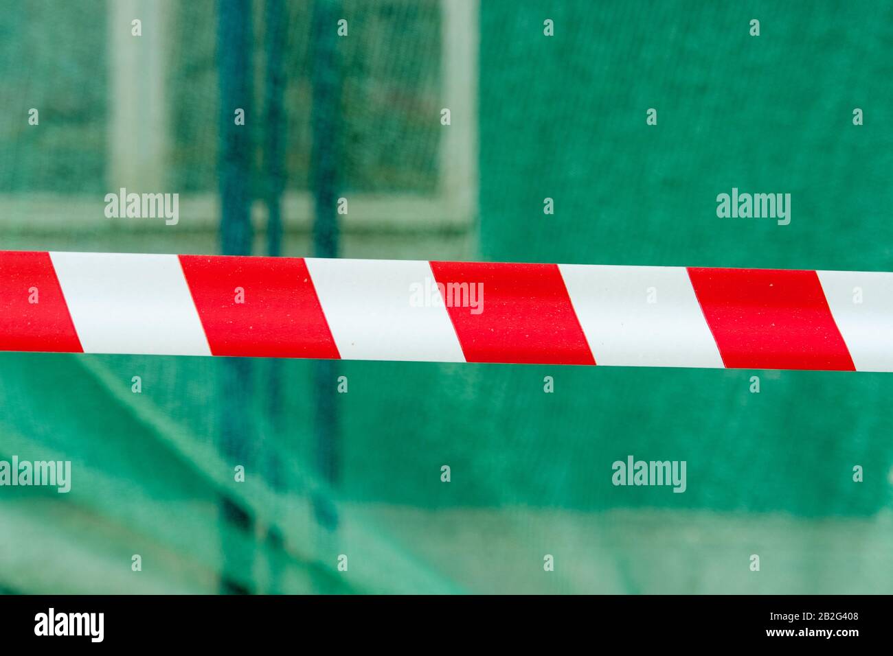 Do not cross red white line on green background Stock Photo - Alamy