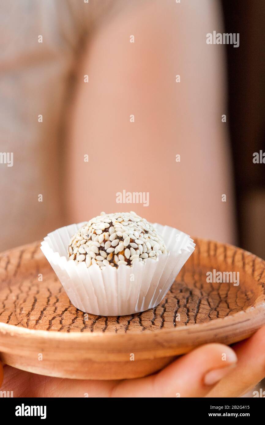 Home made candy with sesame and date on clay plate Stock Photo - Alamy