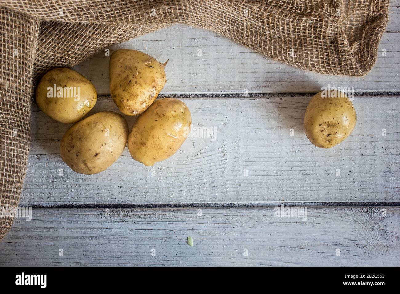 raw baby potatoes on rustic wooden background Stock Photo - Alamy
