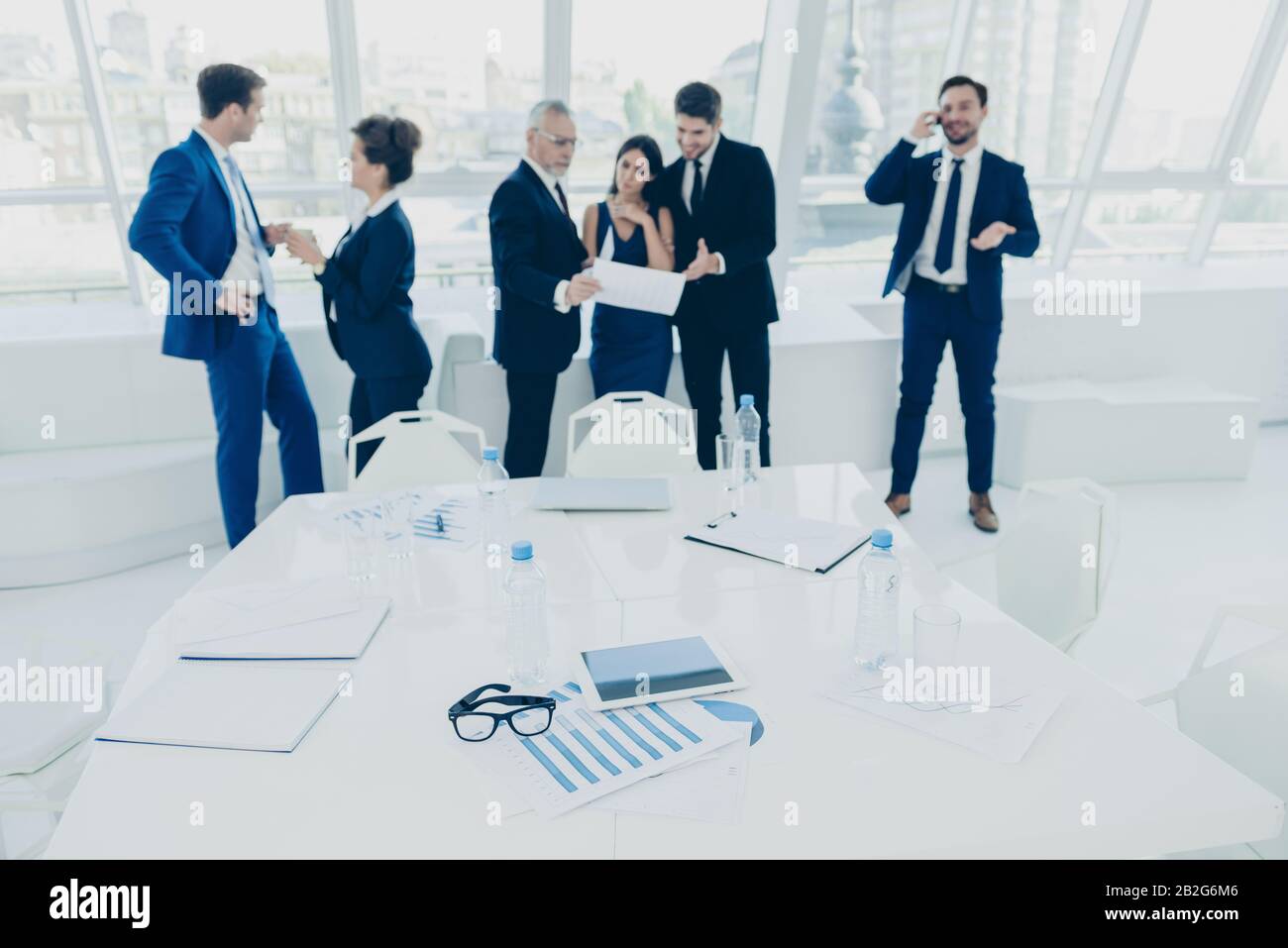 Successful business people having break after meeting Stock Photo - Alamy