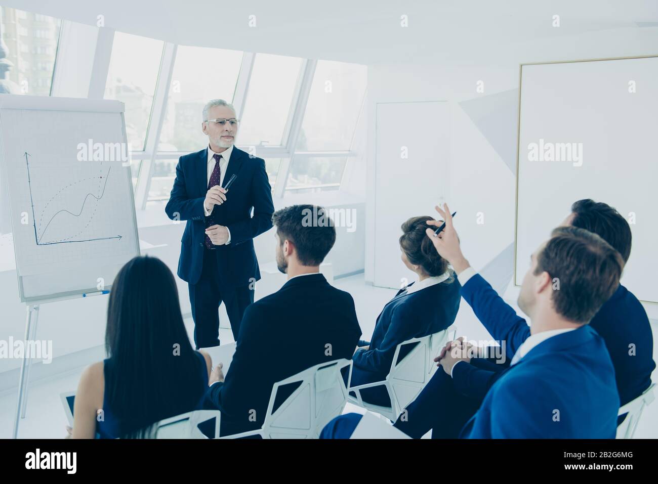 Senior partner making presentation on whiteboard in the office Stock ...