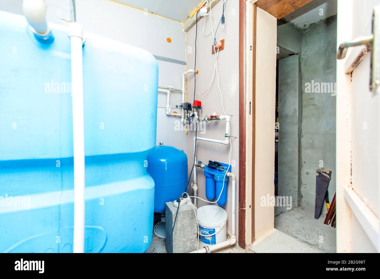 water tanks and pumps for water supply in the basement of the cottage ...