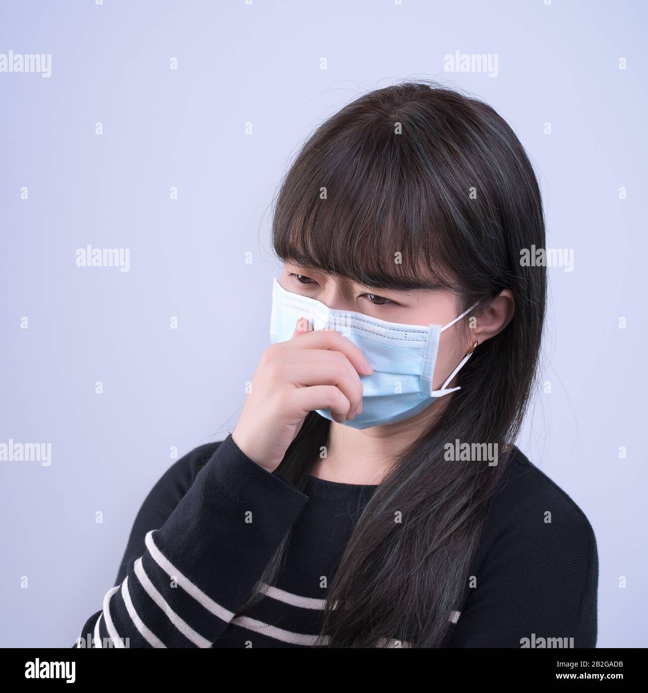 Woman coughing with mask - young Asian covering the mouth, feeling ...