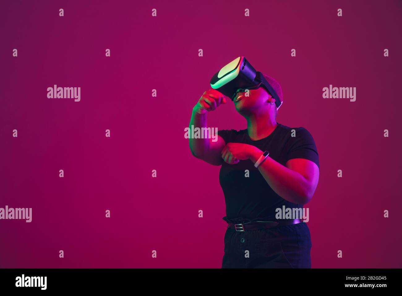 Driving. African-american young woman's portrait on purple background ...