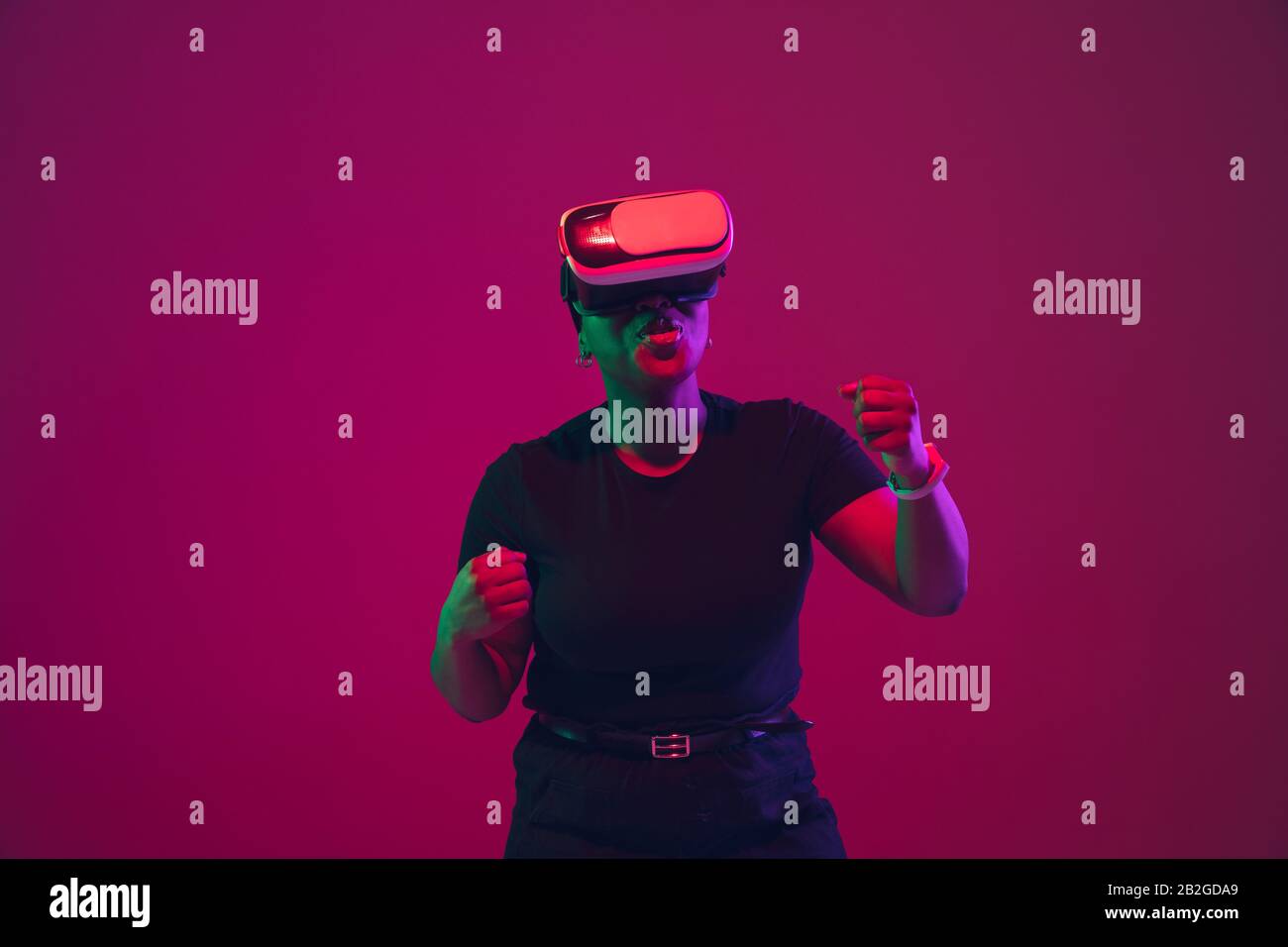 Driving. African-american young woman's portrait on purple background ...