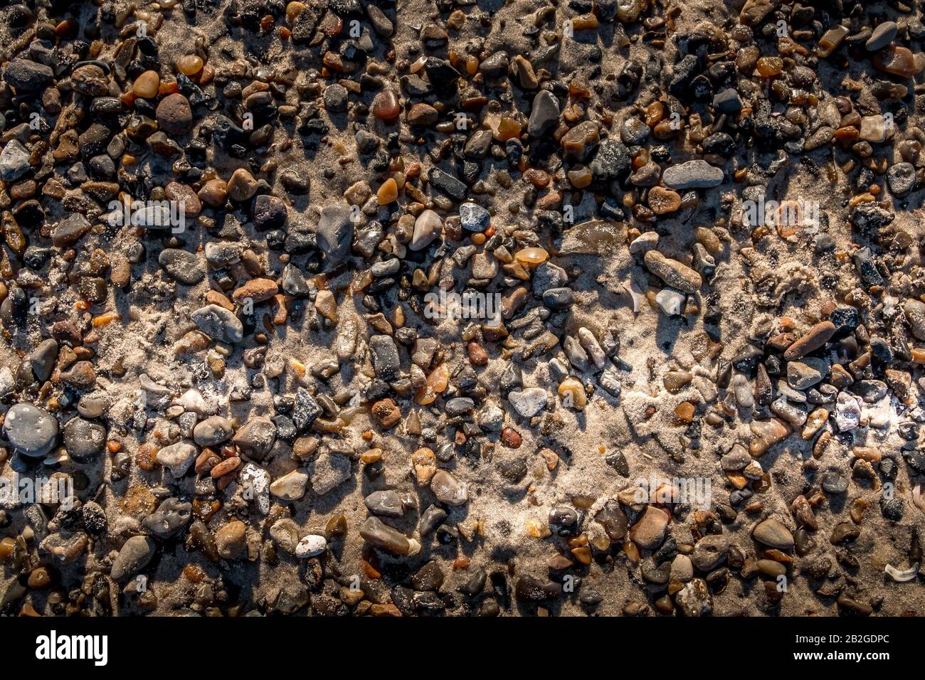 Small beach stone in beautiful sunlight Stock Photo - Alamy