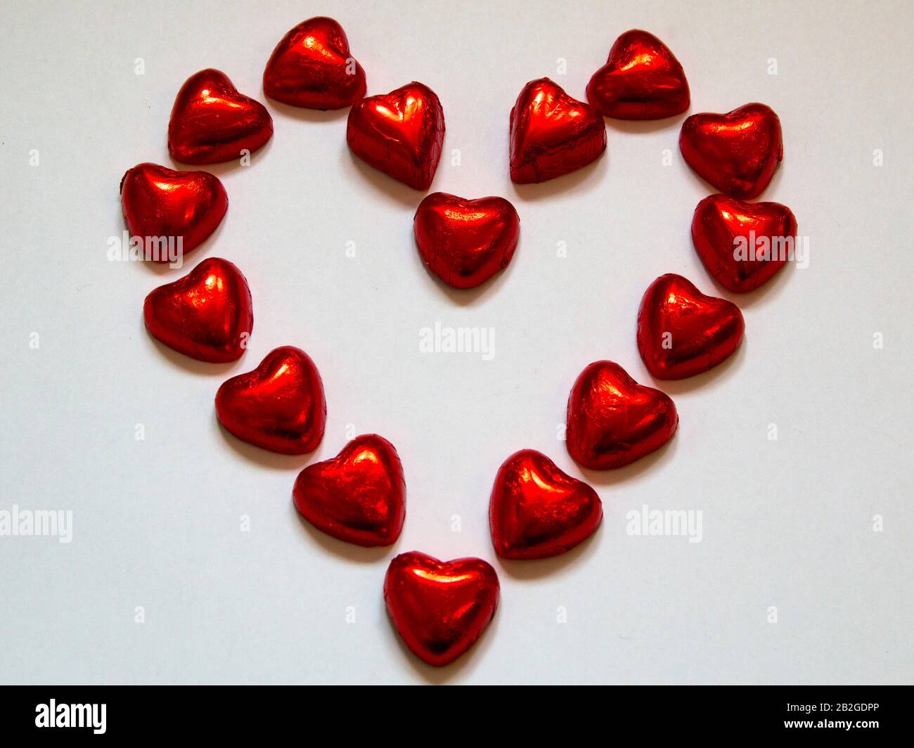 Small red chocolate hearts shaped like a big heart Stock Photo - Alamy