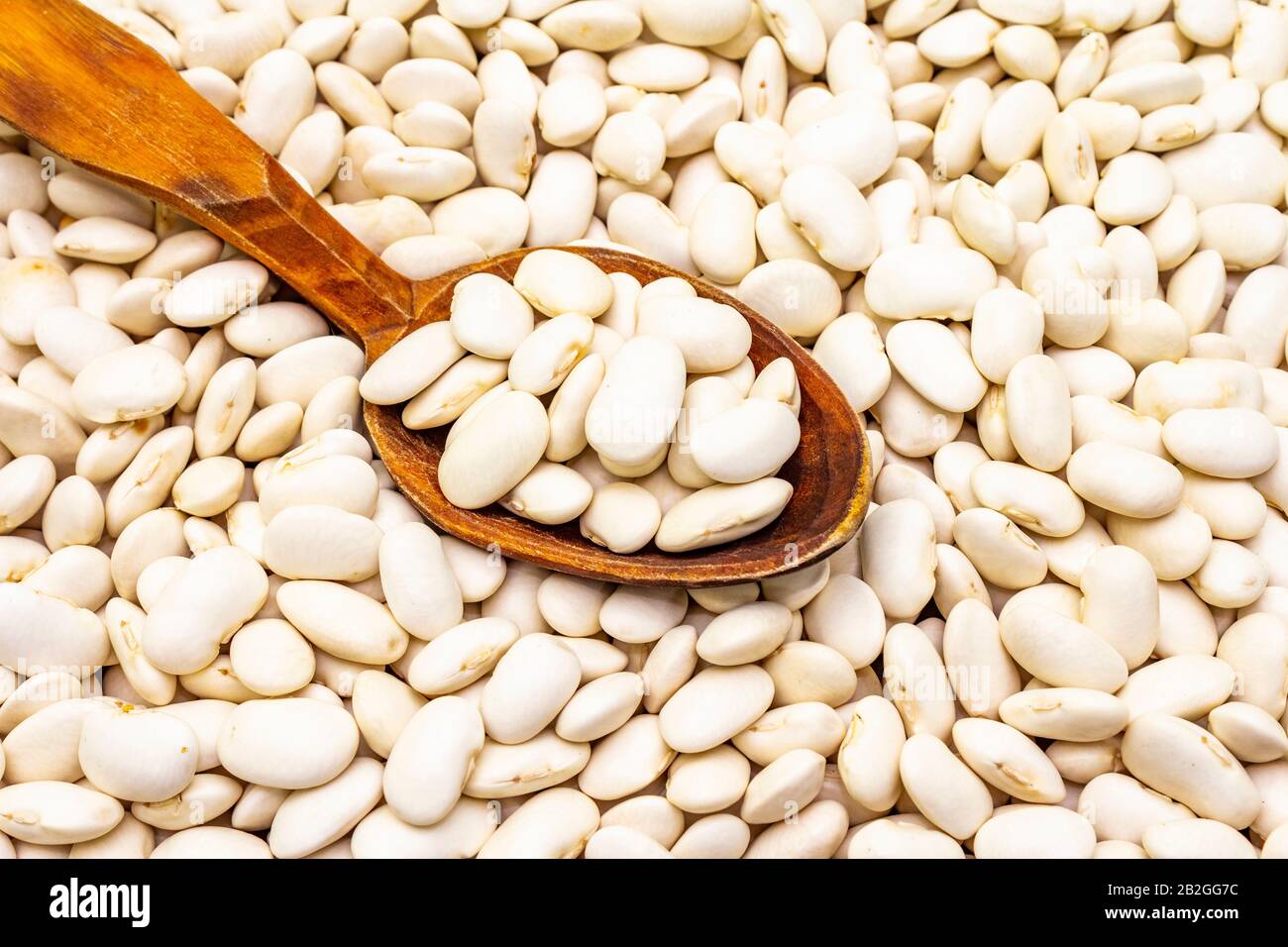 Dry lima beans stone background, with wooden spoon, top view, wallpaper ...