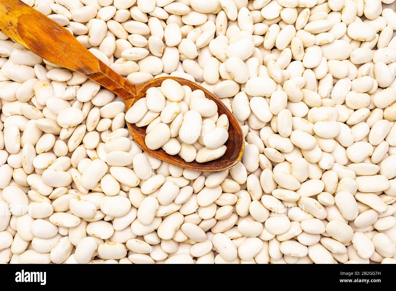 Dry lima beans stone background, with wooden spoon, top view, wallpaper ...