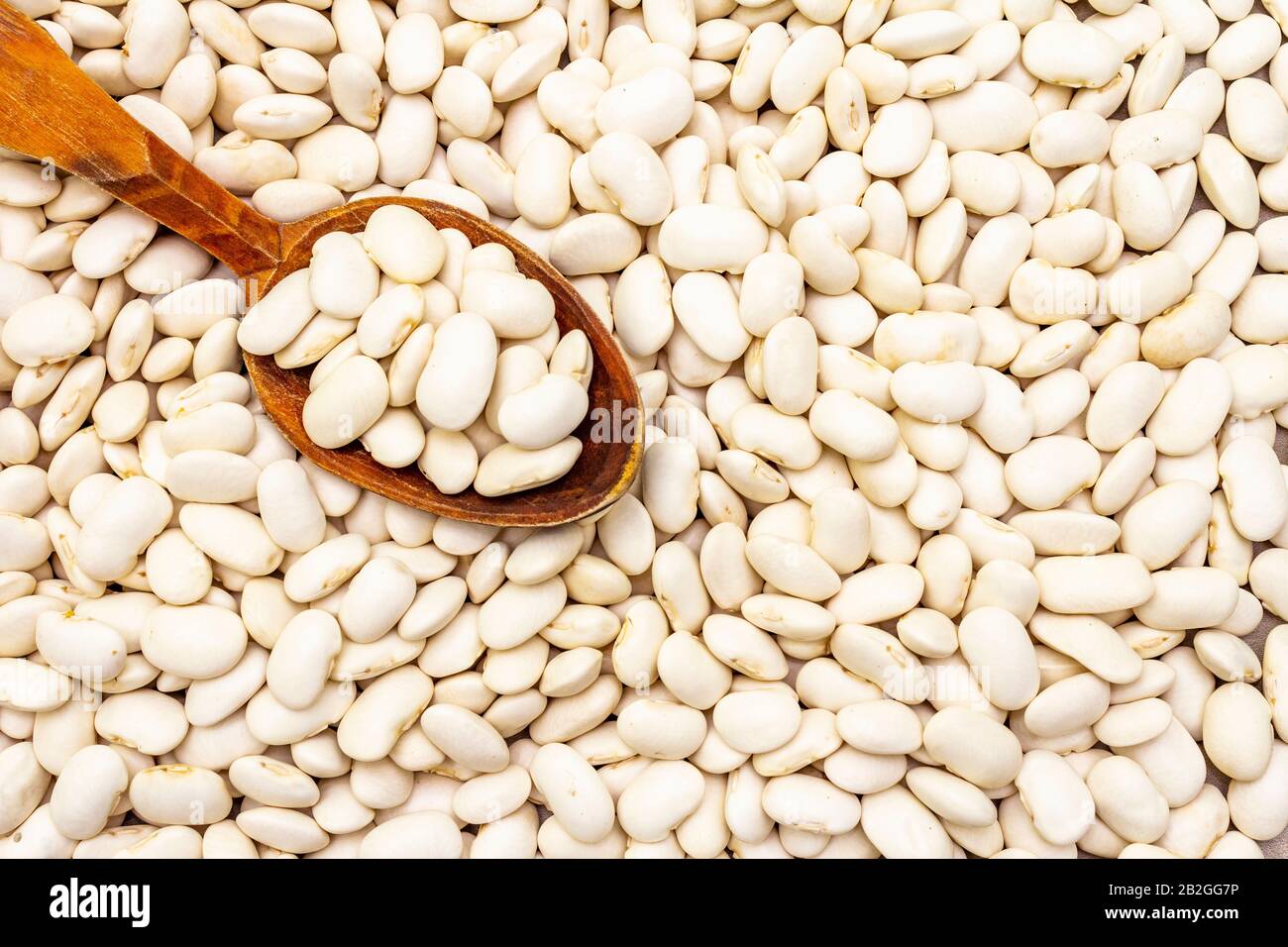 Dry lima beans stone background, with wooden spoon, top view, wallpaper ...