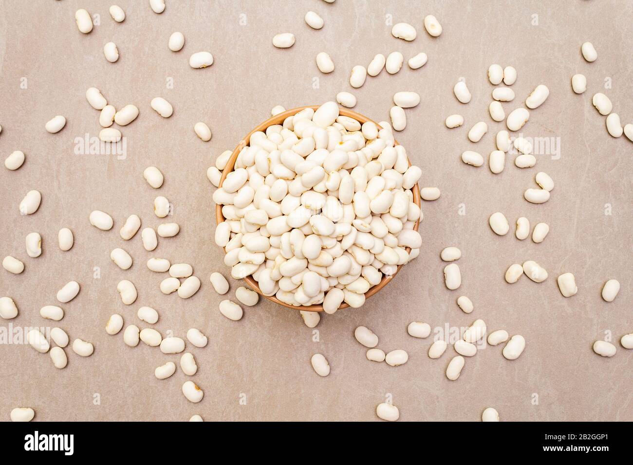 Dry lima beans in ceramic bowl on stone background, top view, wallpaper ...
