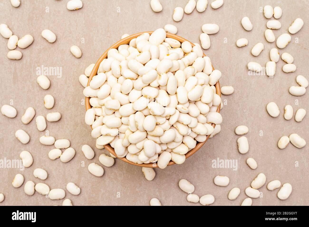 Dry lima beans in ceramic bowl on stone background, top view, wallpaper ...