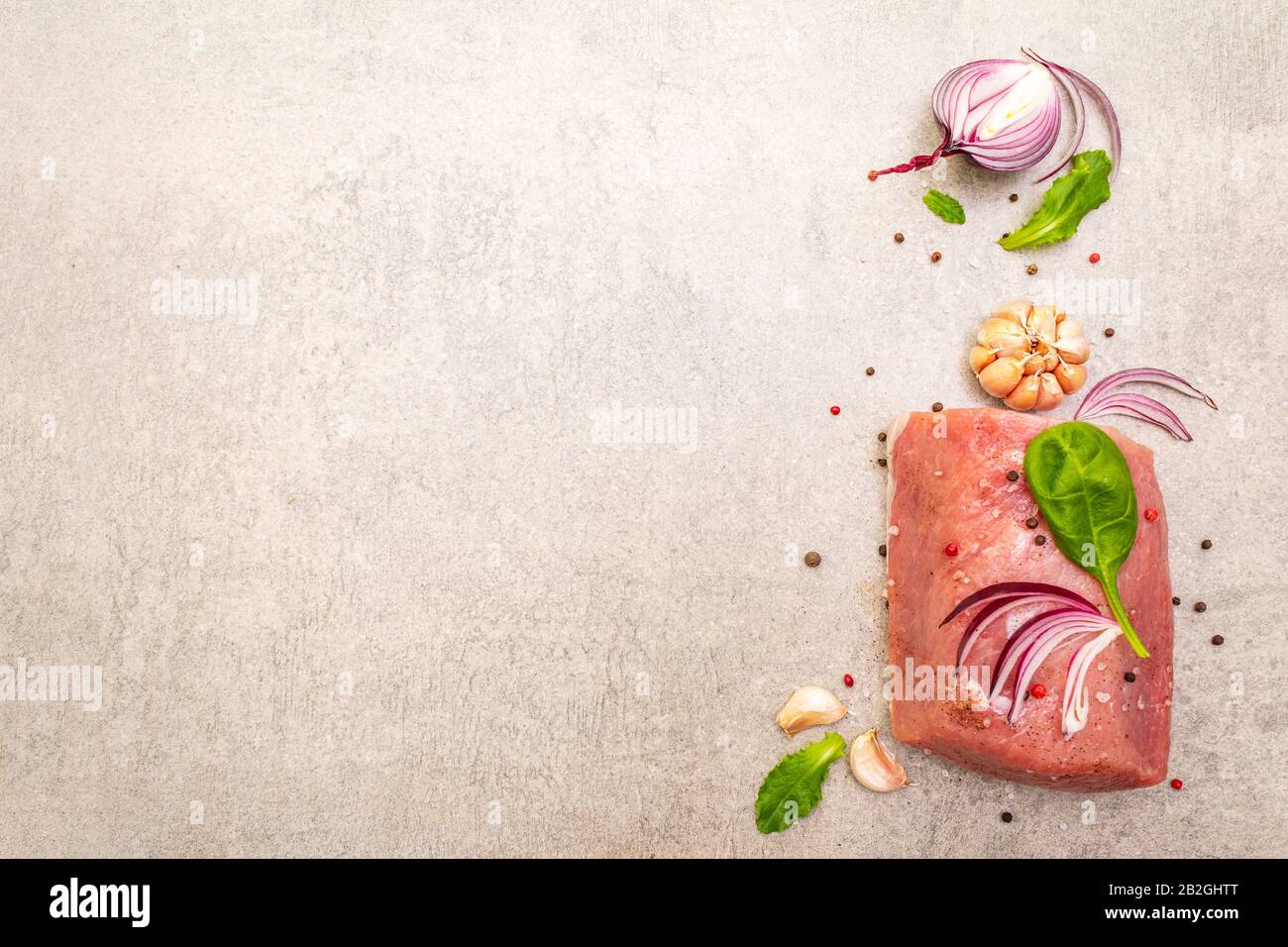 Raw pork tenderloin with vegetables and spices. Cooking meat background ...