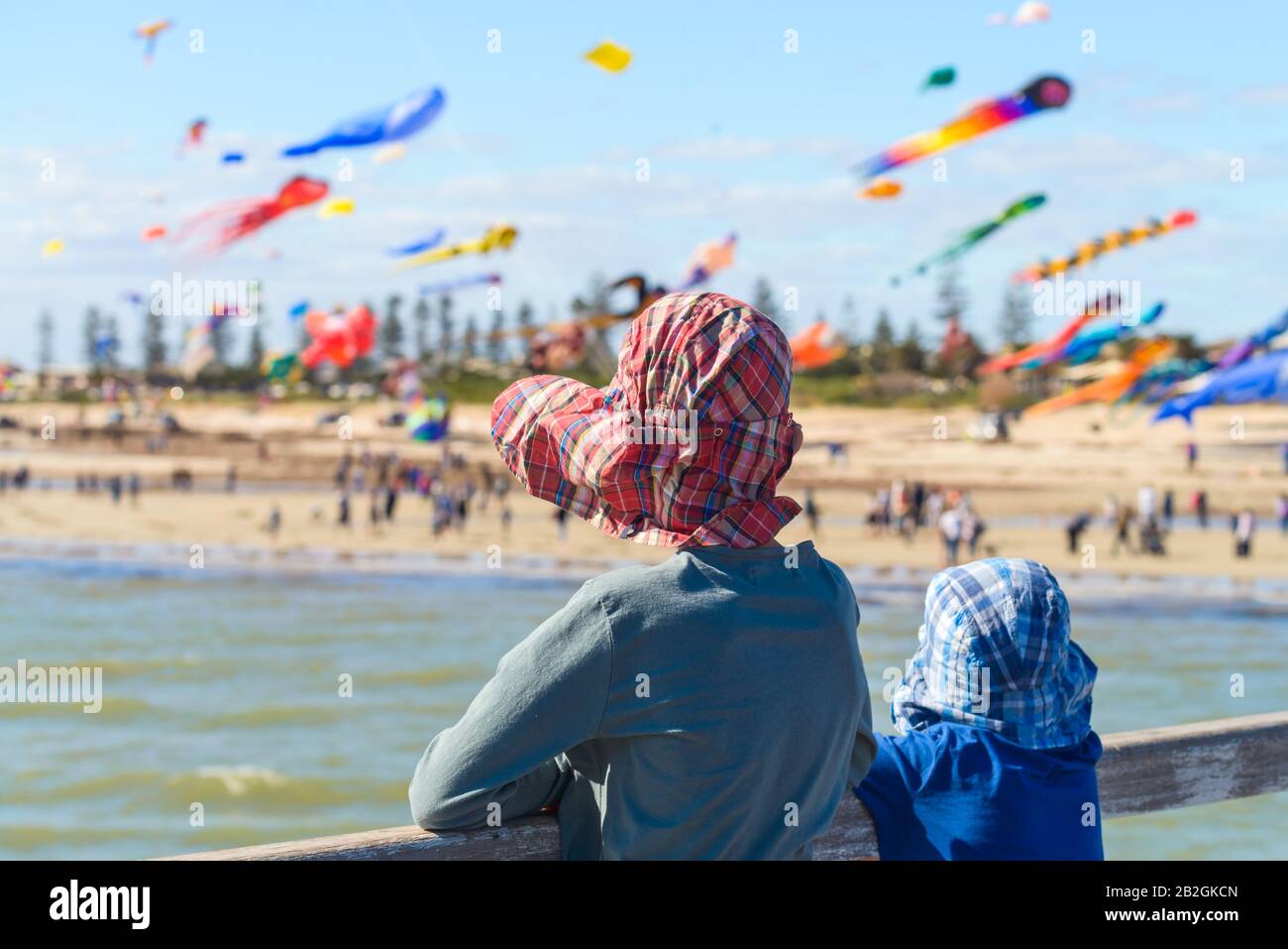 Children watching flying kites from Semaphore Jetty, South Australia ...