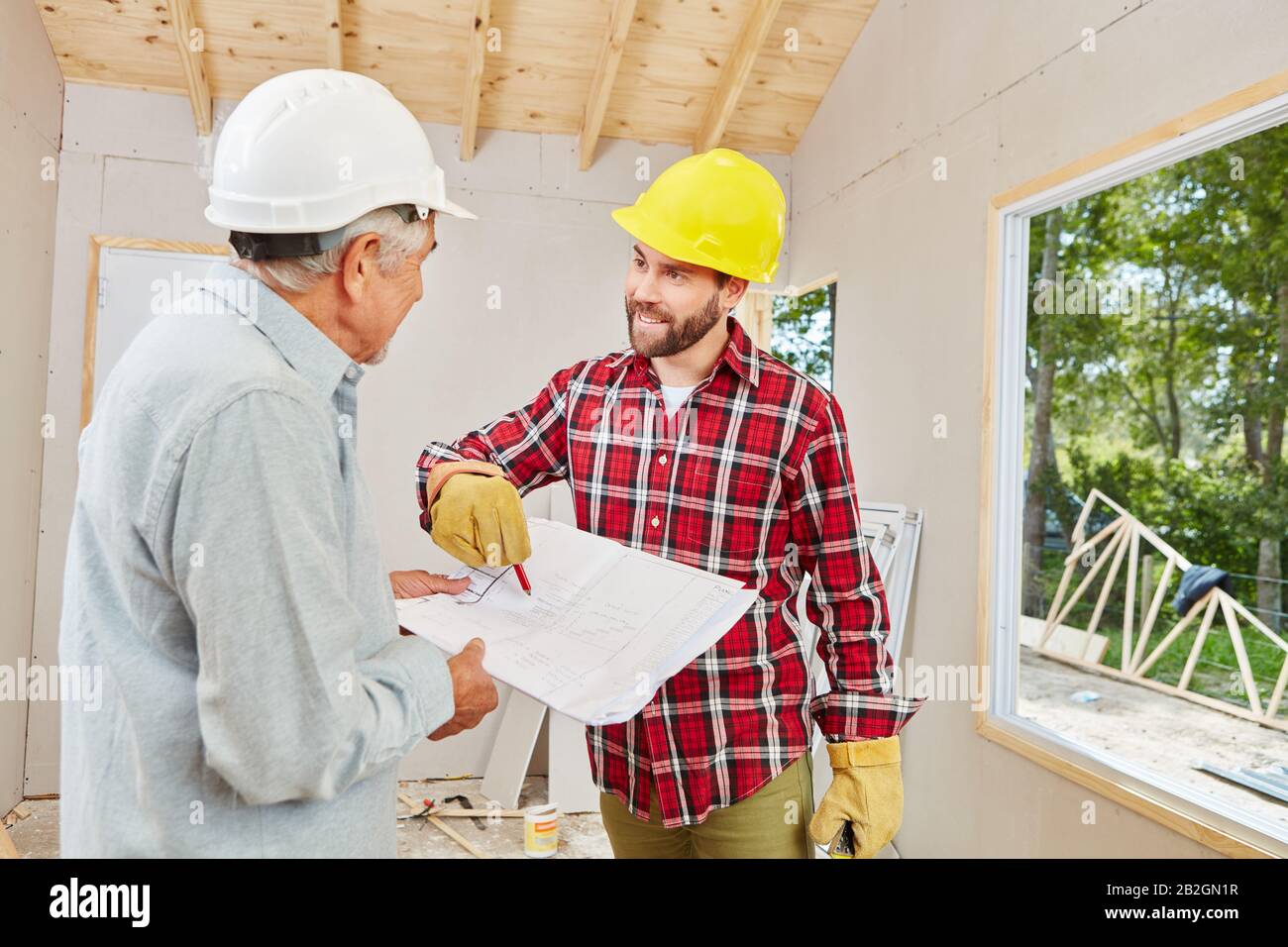 Construction worker and architect on construction site with ...