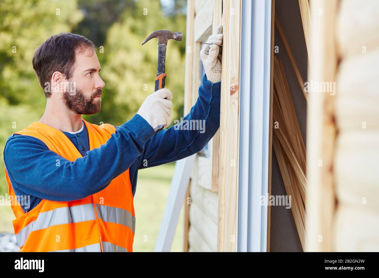 Craftsman building a house with hammer and nail Stock Photo - Alamy