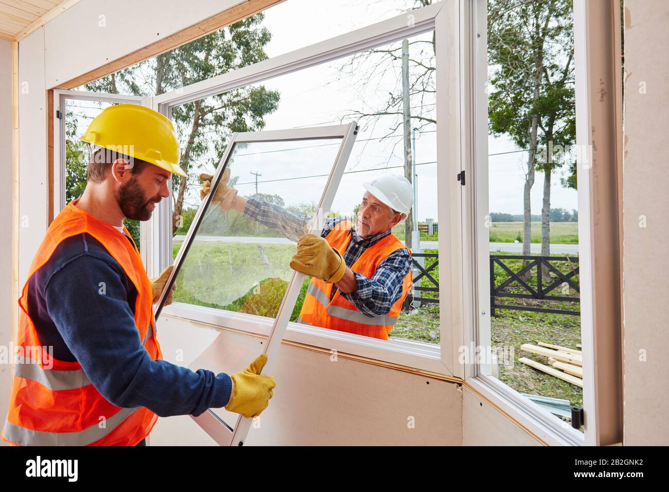 Two fitters from Glaserei build windows when building a house on a ...