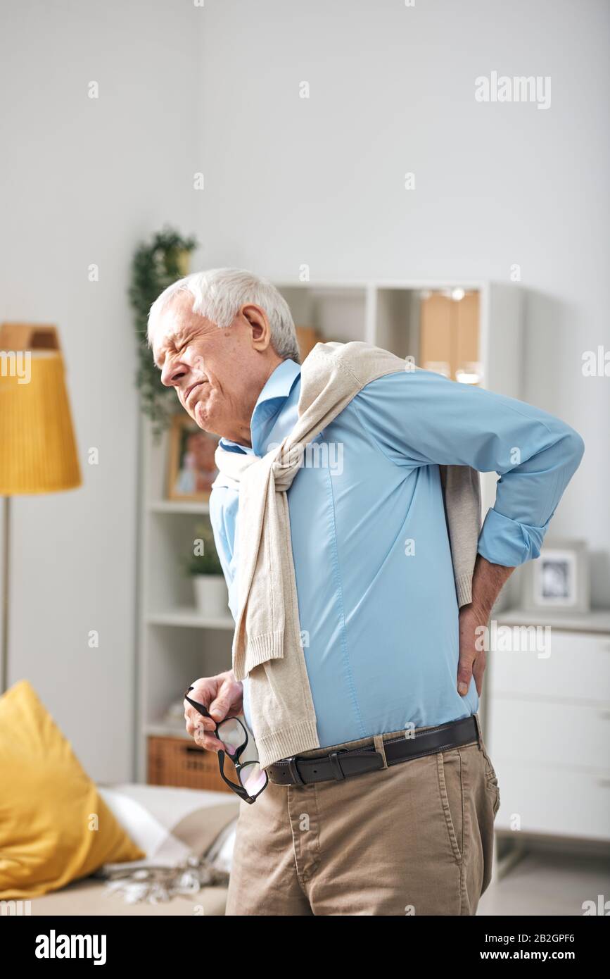 Hand on lower back hi-res stock photography and images - Alamy