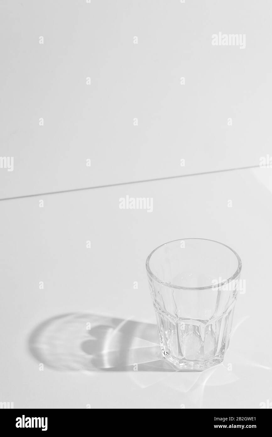 Monochrome photo concept. Empty glass with interesting strong hard ...