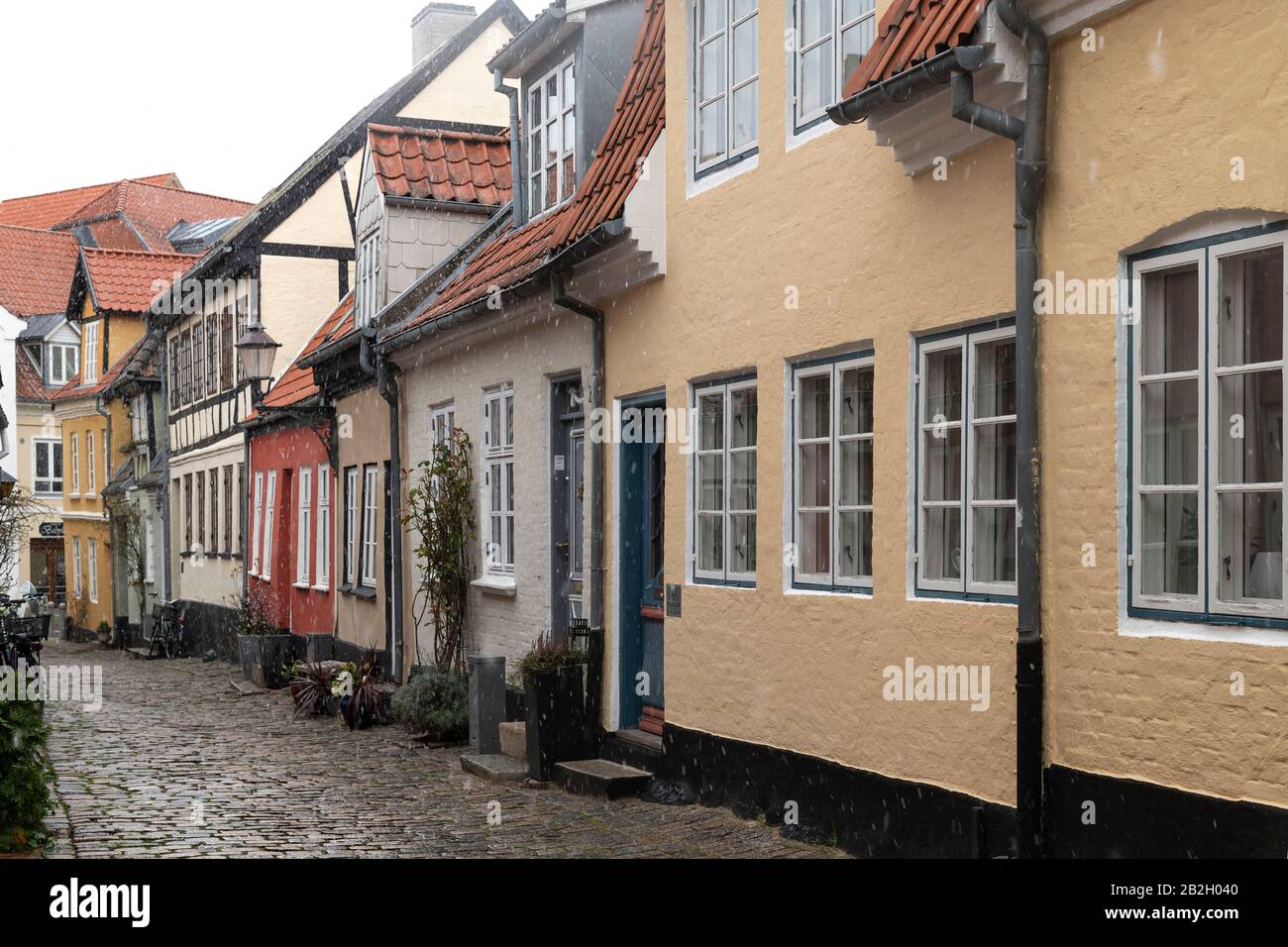 Pretty, colourful cottages in Aalborg, Denmark, on a snowy, winters day ...