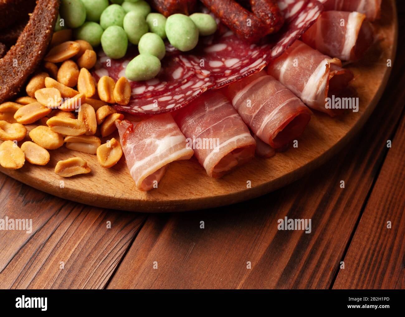Set of snacks on a wooden board for beer and alcohol. Stock photo ...