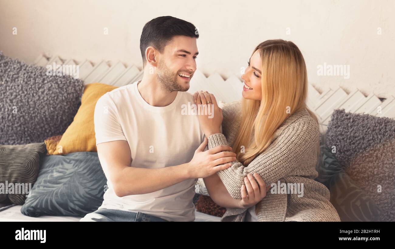 Couple cuddle home hi-res stock photography and images - Alamy