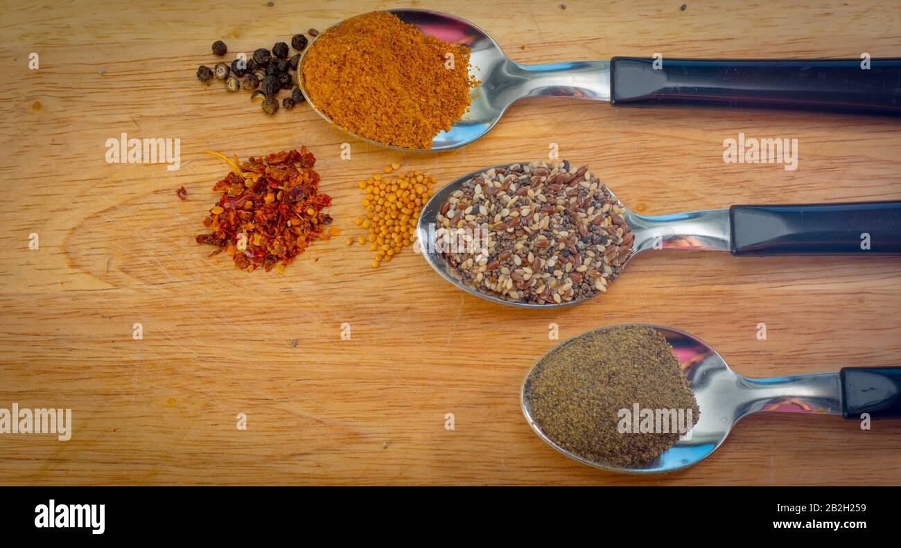 Spoon full of seasoning Stock Photo - Alamy