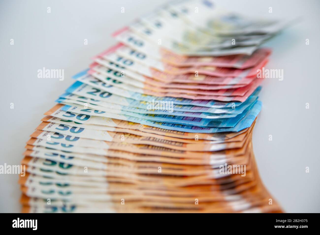 50, 20, 10 and 5 euro bills on a white background. Photographed with ...