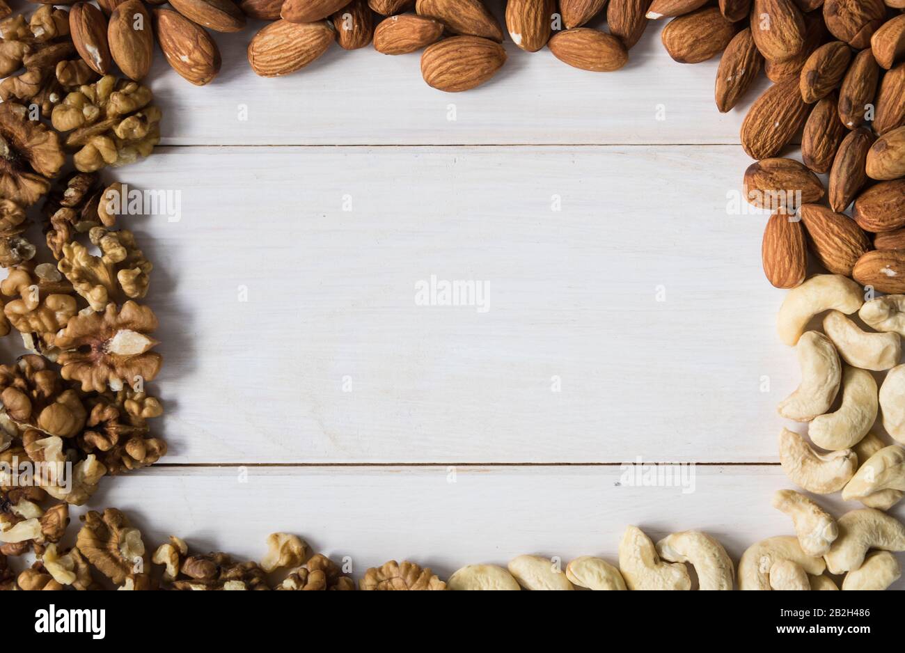 white wooden background framed by a frame of nuts Stock Photo - Alamy