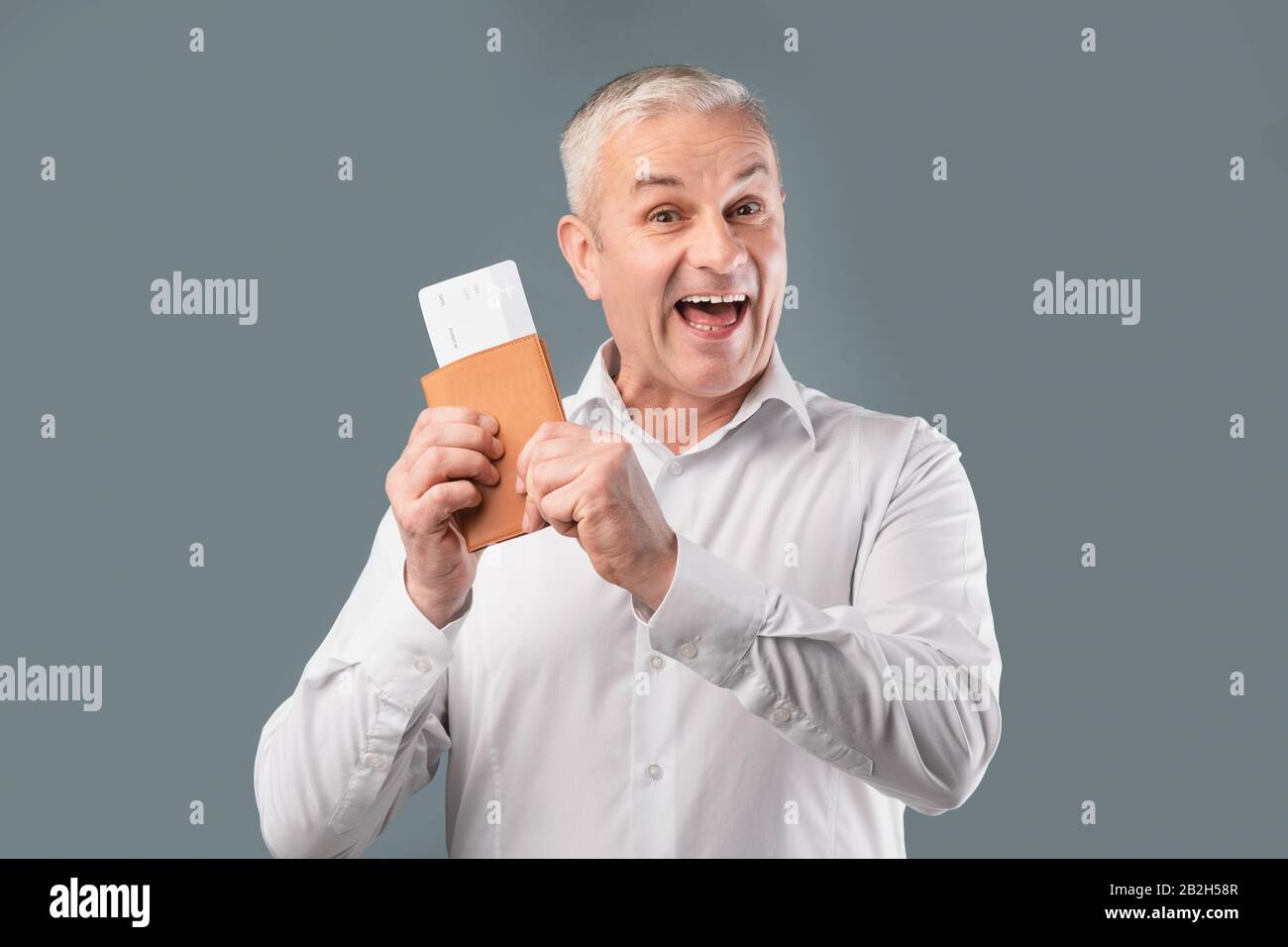 Excited traveler holding tickets hi-res stock photography and images ...