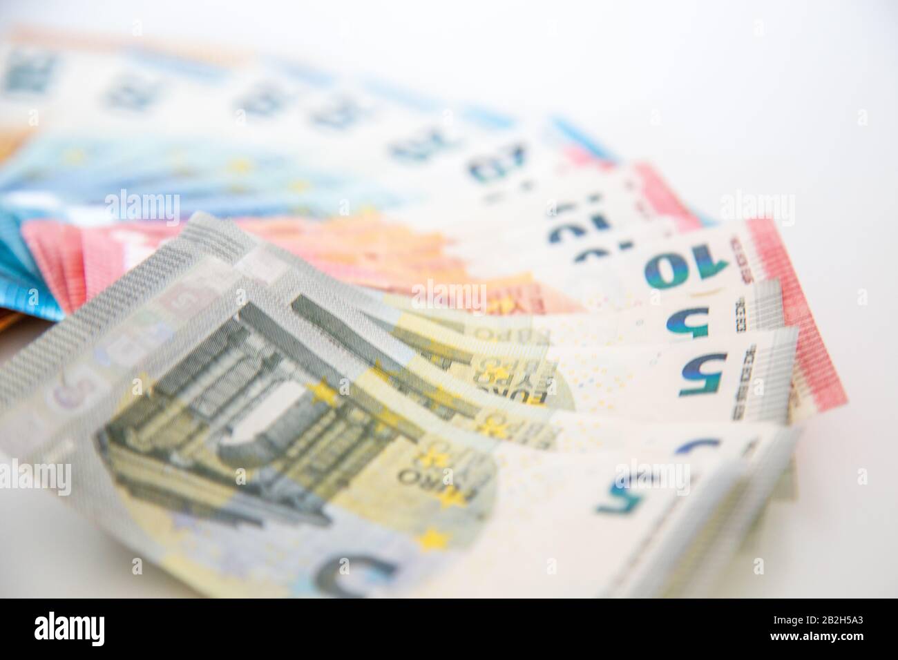 50, 20, 10 and 5 euro bills on a white background. Photographed with ...