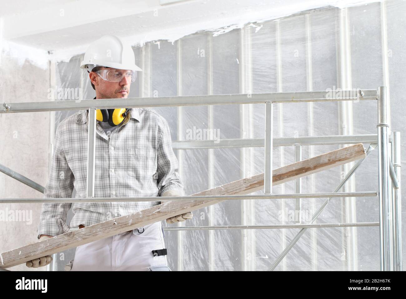 man work, professional construction worker with scaffolding, safety ...
