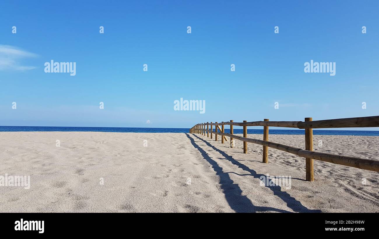 empty beach by the sea with fence Stock Photo - Alamy