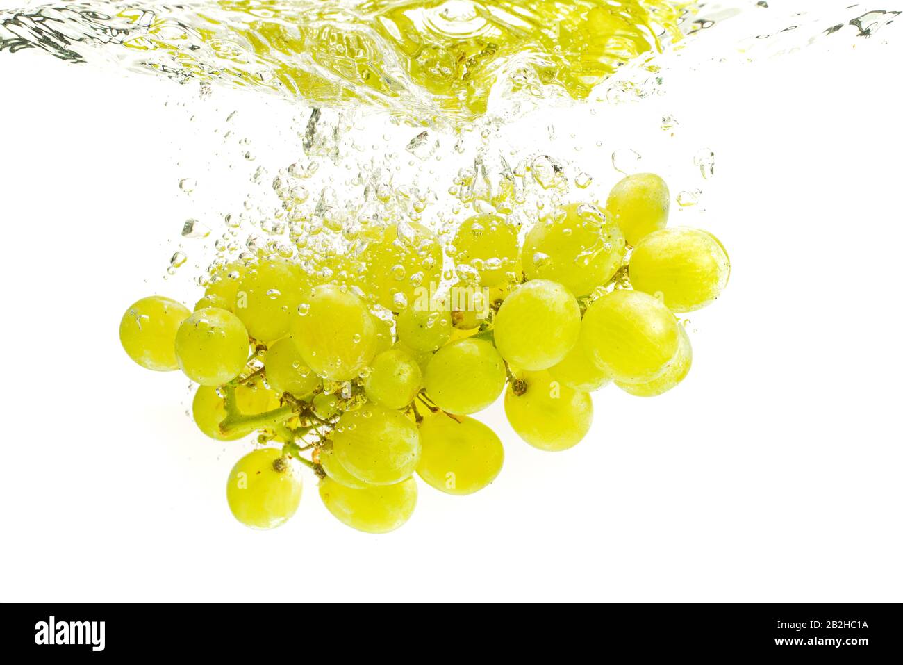 Bunch of green grapes sinking into crystal clear water Stock Photo - Alamy