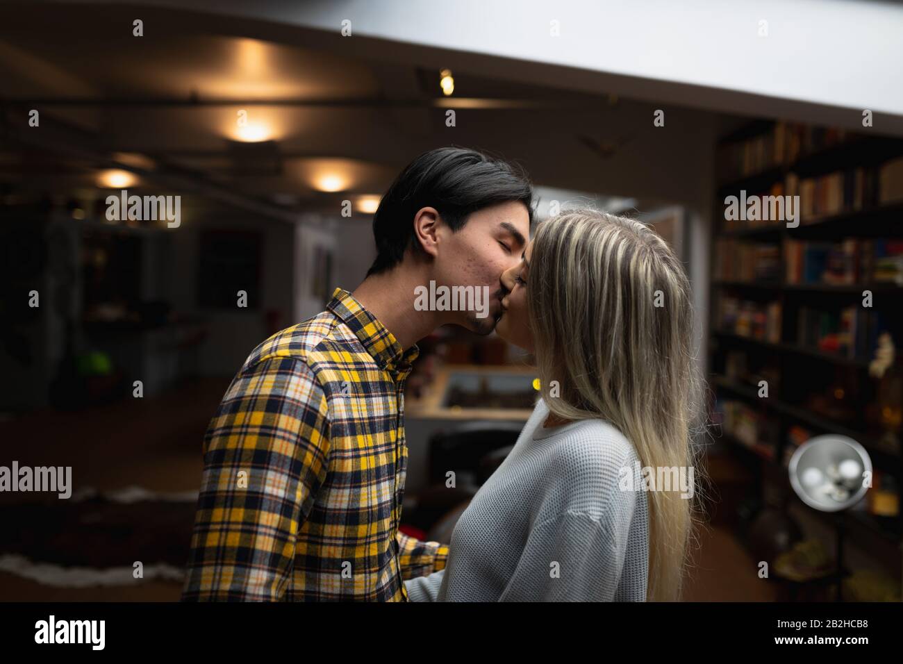 Young couple kissing while standing Stock Photo - Alamy